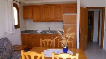 Um frigorífico/congelador grande, um micro-ondas, uma placa de cozinha