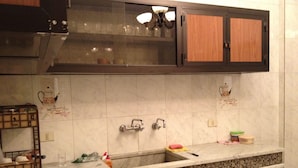 Uma cozinha com pia, armários e bancada.