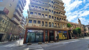 Um edifício de vários andares com uma loja no térreo identificada como 
