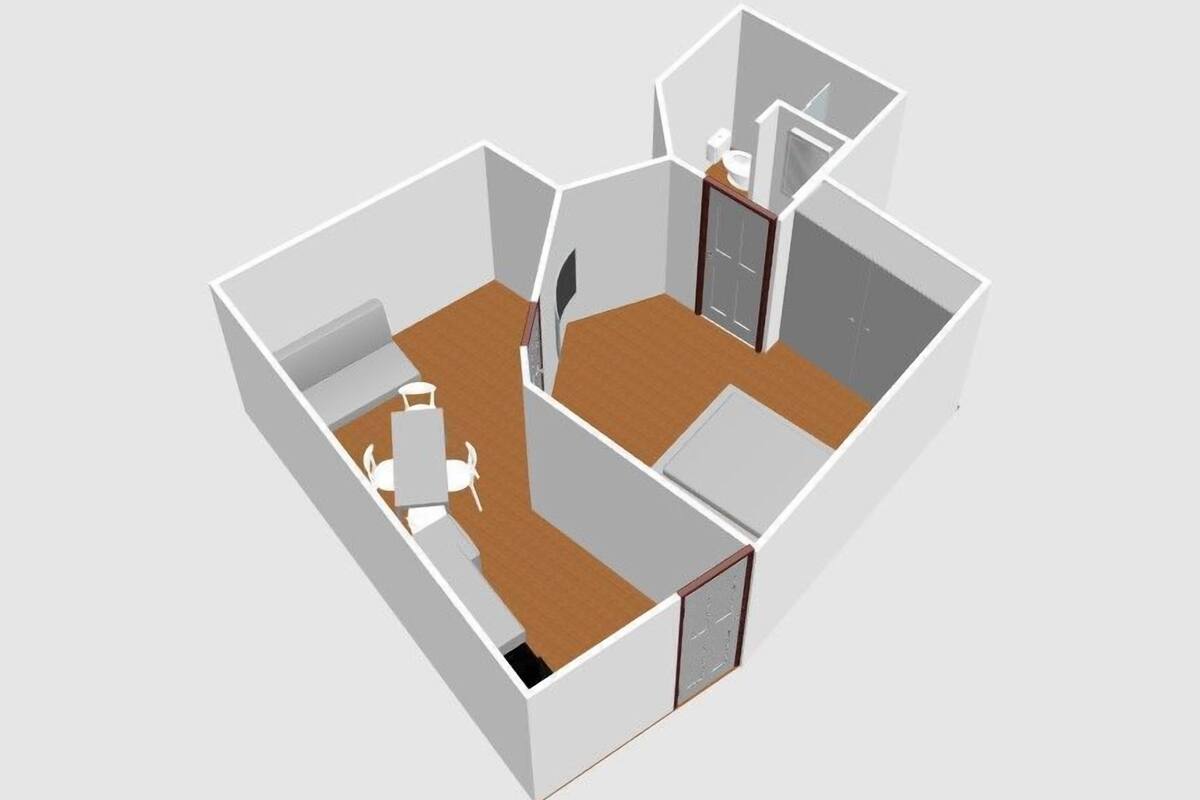 Planta baixa em 3D de um quarto de hotel, com cama, escrivaninha, cadeira, guarda-roupa e banheiro.