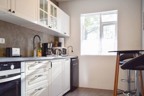 Um frigorífico/congelador grande, um forno, uma placa de cozinha 