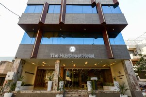 Hotel HubStreet com fachada moderna, janelas amplas e entrada imponente.