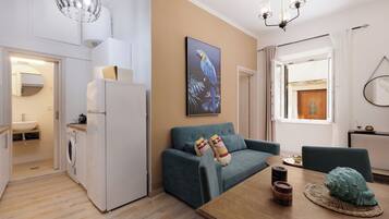 Apartamento, 1 quarto | Área de estar | TV de tela plana