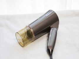 Um secador de cabelo com uma parte transparente e um cabo.