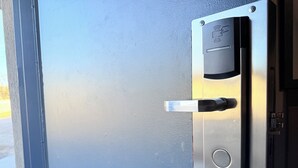 Uma porta com leitor de cartão-chave e mecanismo de fechadura.
