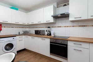 Um frigorífico, um micro-ondas, um forno, uma placa de cozinha