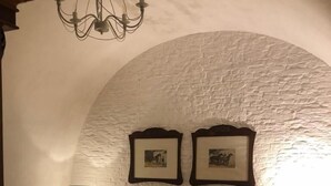Quarto aconchegante com uma cama grande, duas luminárias de cabeceira e um candelabro.