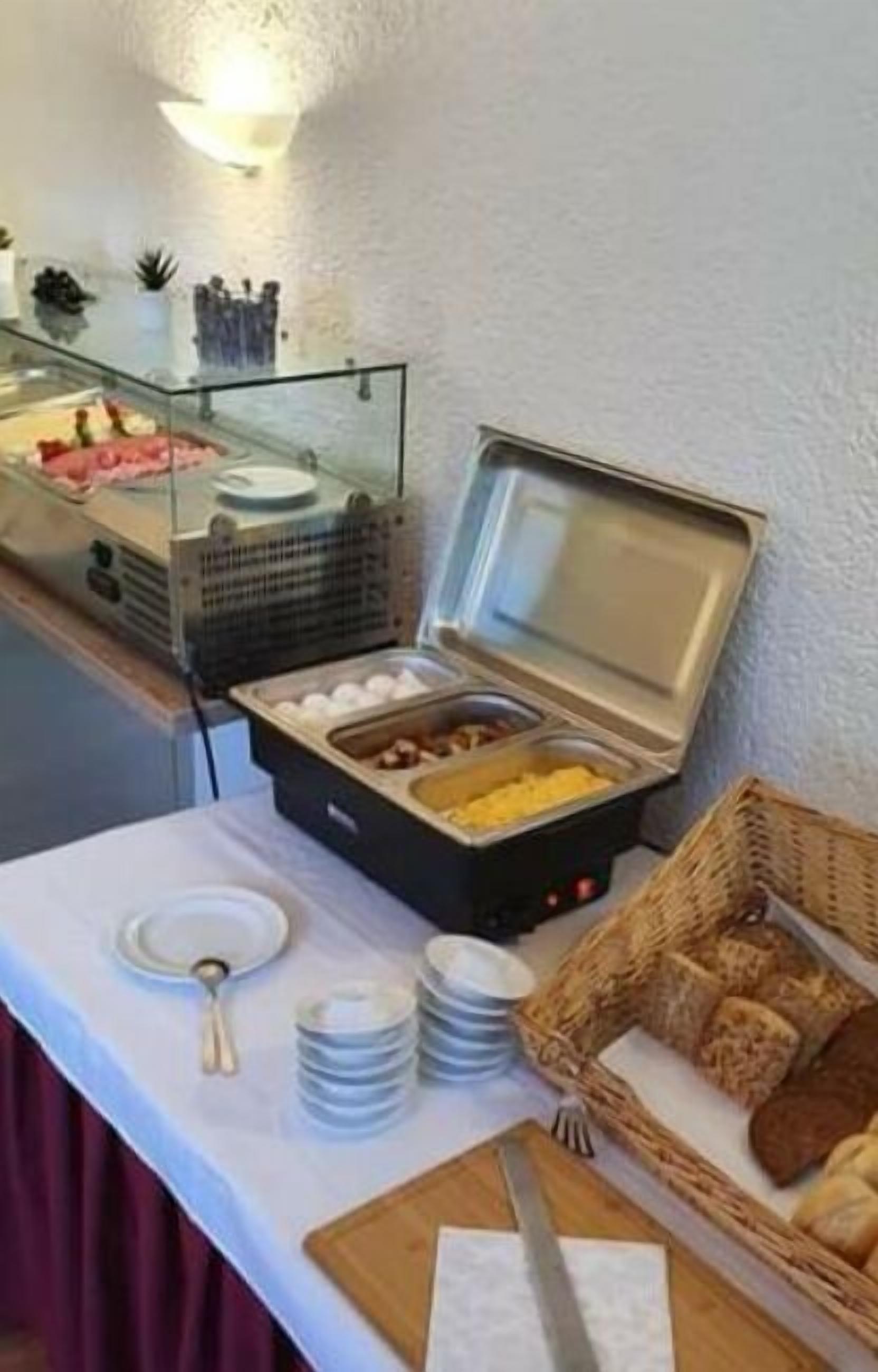 Disposição de buffet com diversos alimentos e utensílios.