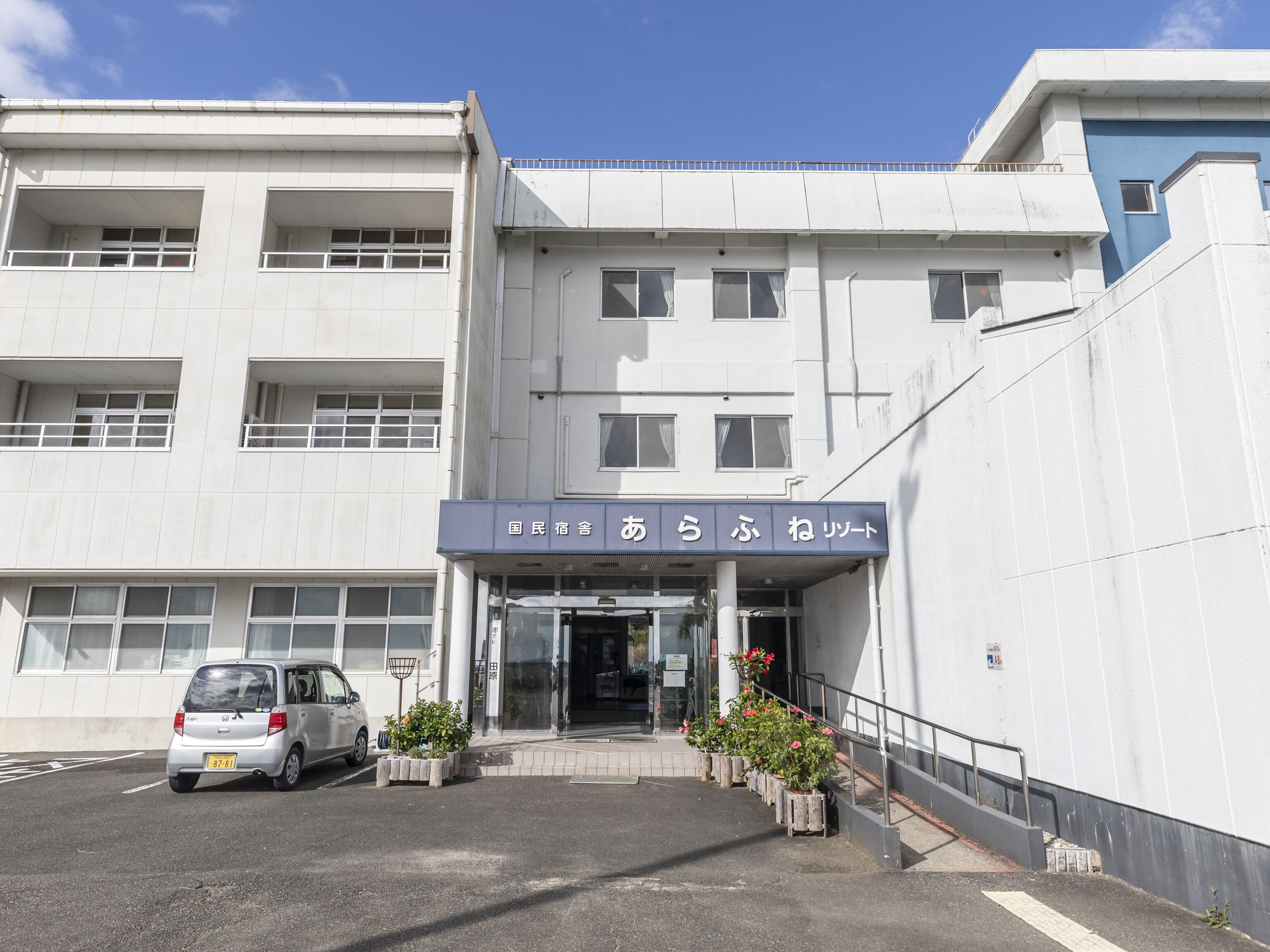 Um edifício com uma placa que diz '国民宿舍 あらふねリゾート'.