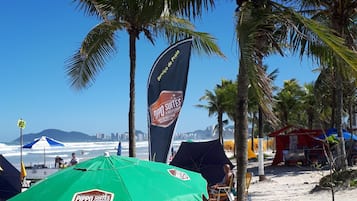Perto da praia, espreguiçadeiras, guarda-sóis
