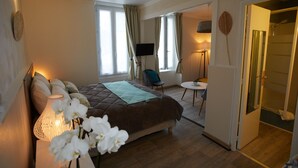 Quarto com cama, escrivaninha e banheiro.