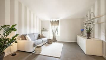 Apartamento premium | Área de estar | TV