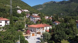 Zona residencial com casas, uma linha de energia e um carro.