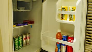 Um frigorífico com prateleiras contendo diversas bebidas, incluindo Sprite, Fanta e Coca-Cola.