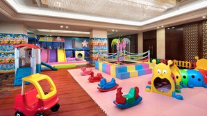 Uma área de recreação infantil com diversos brinquedos e estruturas lúdicas.