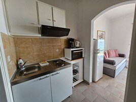 Apartamento | Cozinha privada | Geladeira, cooktop, chaleira elétrica