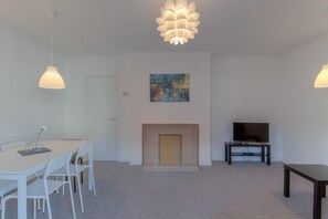 Apartamento família, várias camas, vista para a baía, no piso térreo | Área de estar | Smart TV