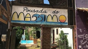 Placa com o texto 'Pousada do Massimino', indicando um estabelecimento de hospedagem.