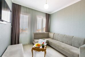 Suíte luxo | Área de estar | TV LED 55 polegadas com canais via satélite, TV