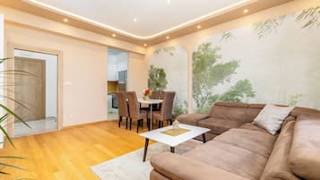 Apartamento conforto, 2 quartos | Área de estar | Smart TV 125 cm com canais a cabo