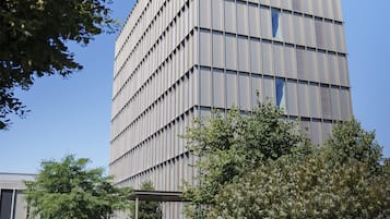 Um edifício moderno com fachada em forma de grade e uma placa com a inscrição 'Yotel'.