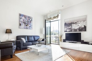 Apartamento luxo, 1 quarto | Sala de estar | TV de tela plana