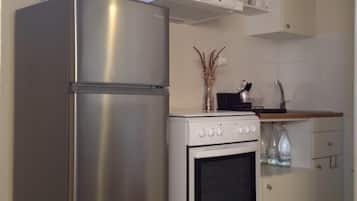 Um frigorífico/congelador grande, um forno, uma placa de cozinha