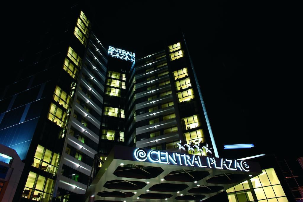 Um edifício de vários andares com letreiros iluminados que dizem "CENTRAL PLAZA".
