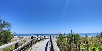 Perto da praia, areia branca, prática de vôlei de praia, bar na praia 