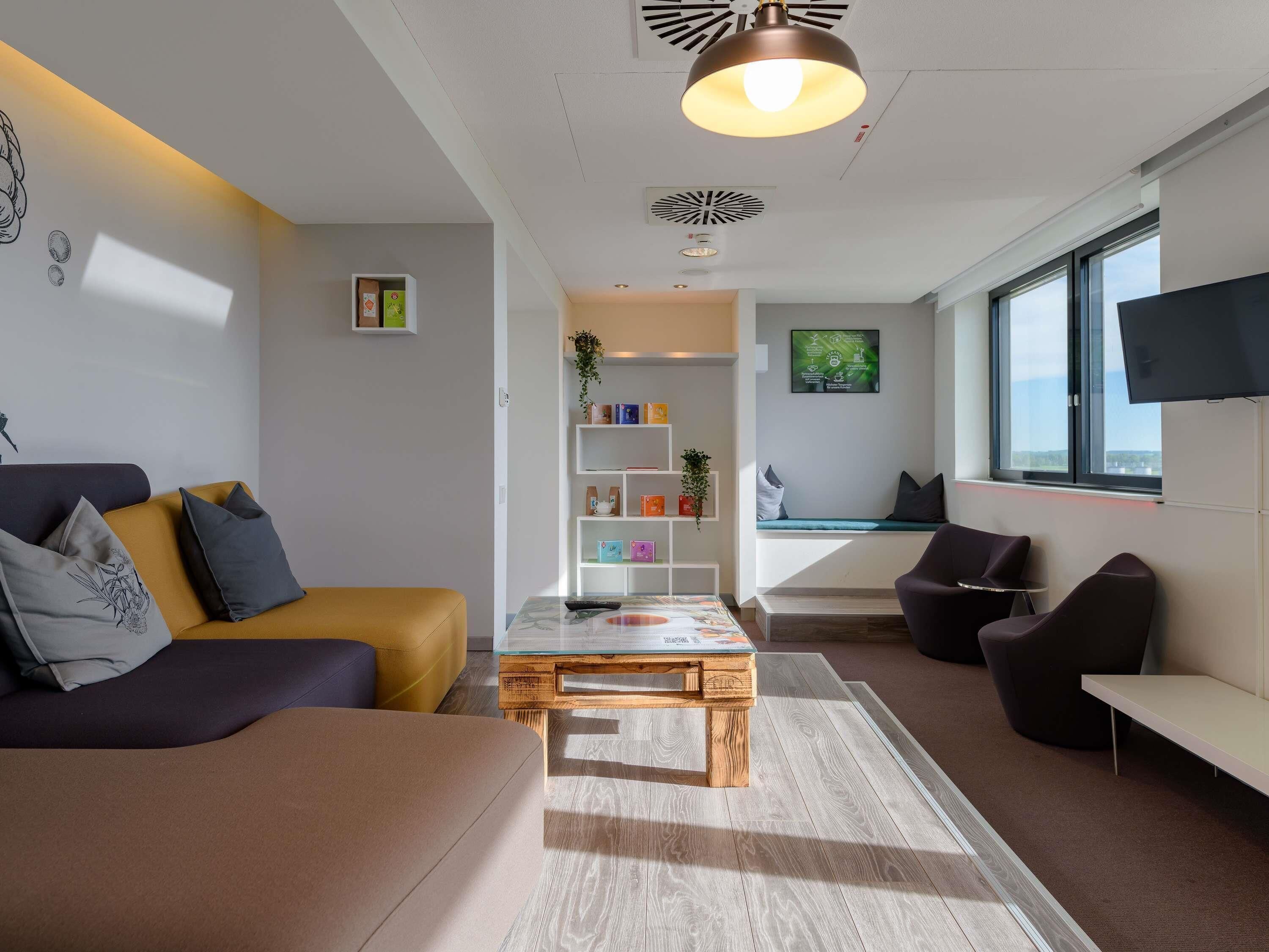 Uma sala de estar moderna com sofá, mesa de centro e área de estar.