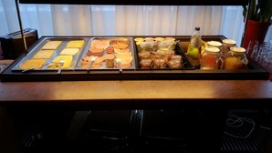 Um buffet com diversos alimentos e acompanhamentos.