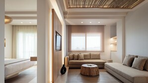 Uma sala de estar moderna com um sofá, uma mesa de centro e uma cama com cabeceira embutida.