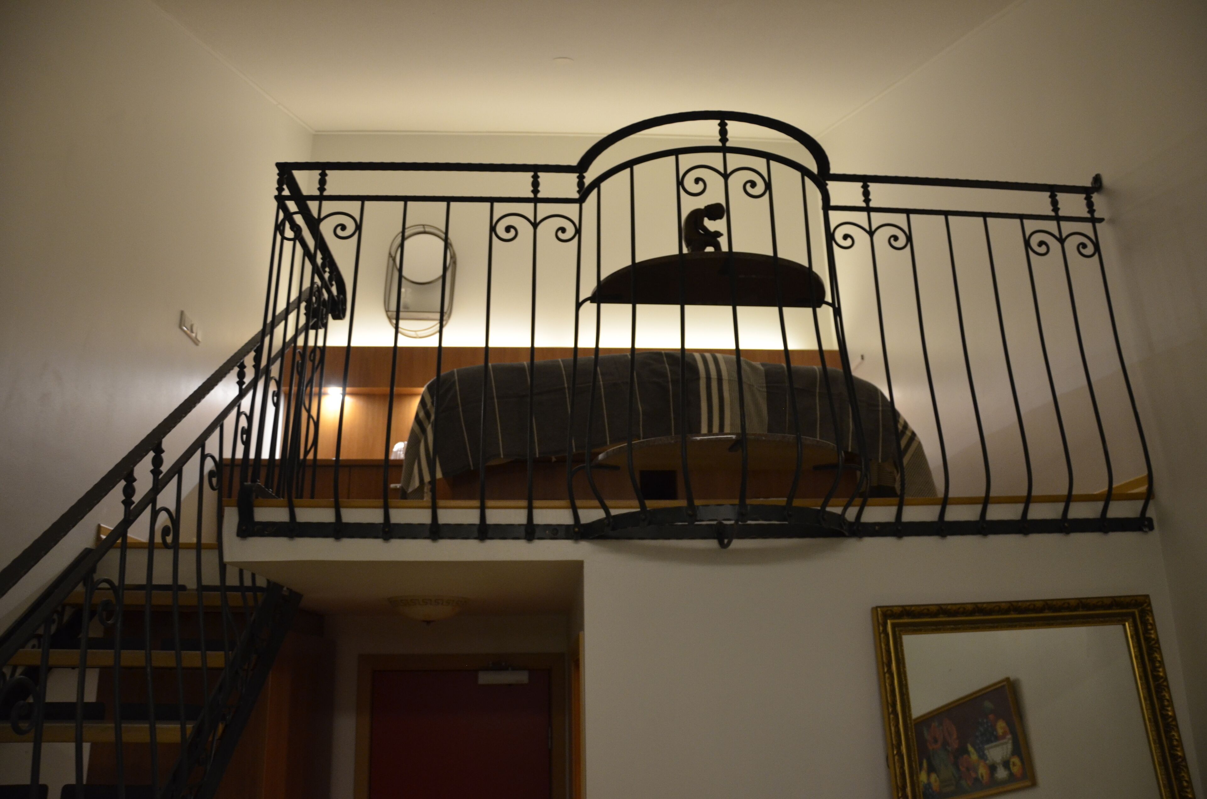Uma escadaria com corrimão de metal que leva a um patamar.