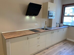 Apartamento Deluxe, cozinha | Cozinha privada