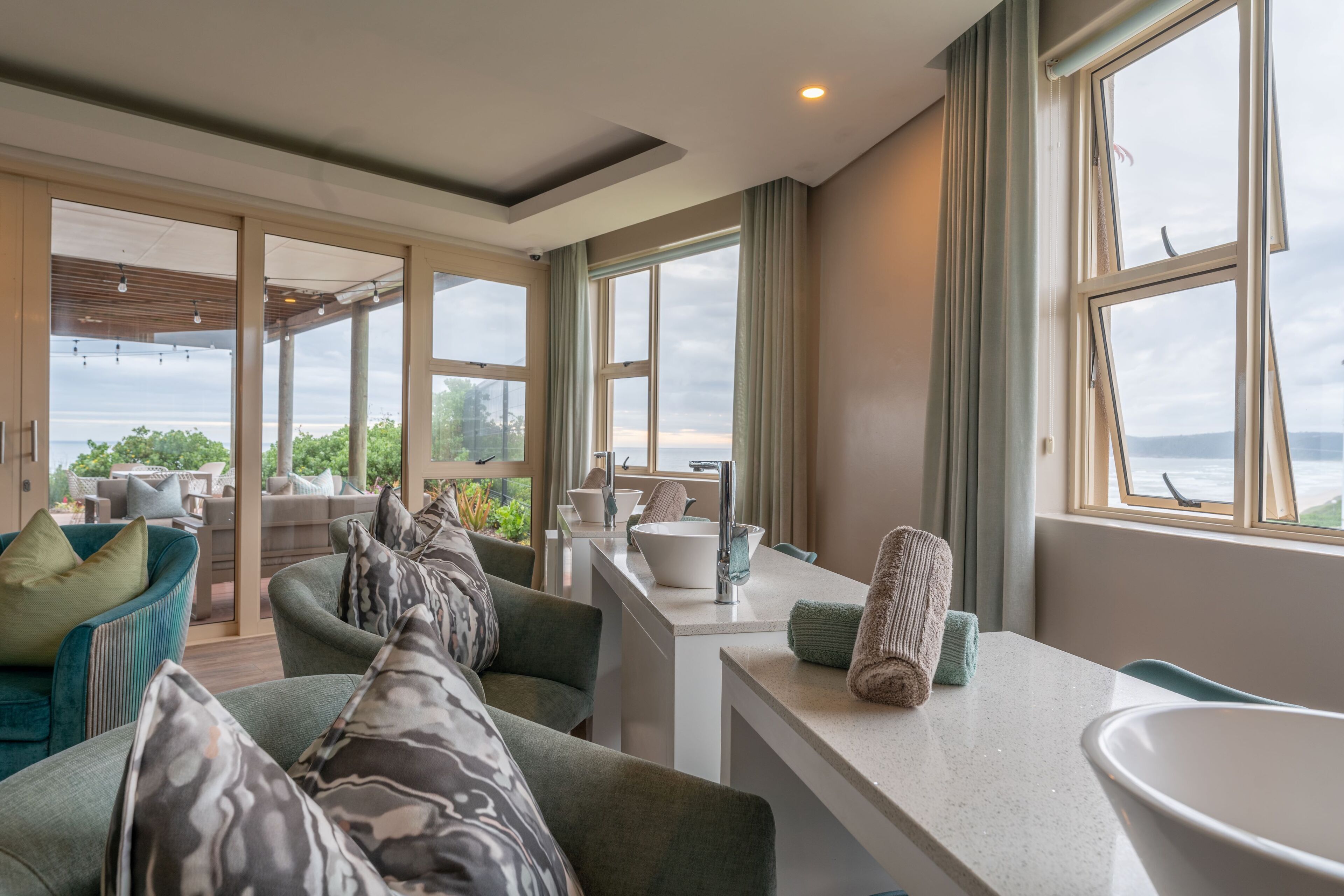 Quarto moderno com janela ampla, cozinha e área de estar com vista para o exterior.