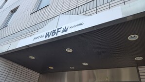 Placa de hotel com o nome 'HOTEL WBF KUSHIRO'.