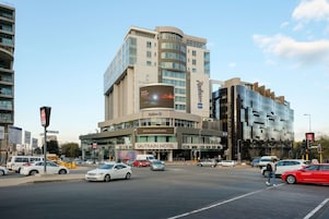 Um hotel com design moderno, vários andares e uma placa bem visível.