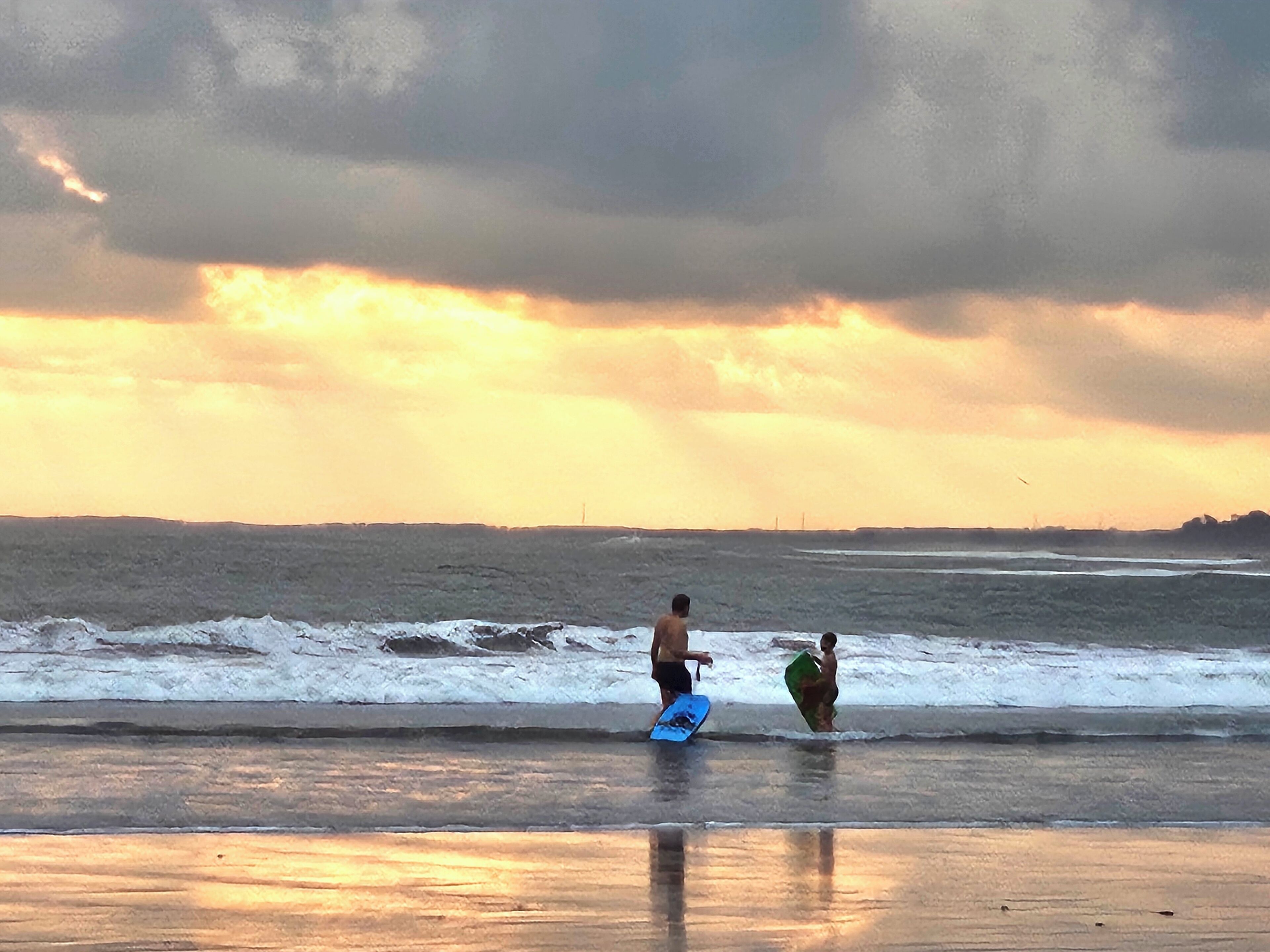 Cena de praia com ondas e céu nublado.