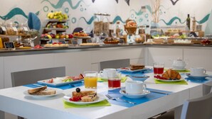 Um buffet de café da manhã com diversos alimentos e bebidas.