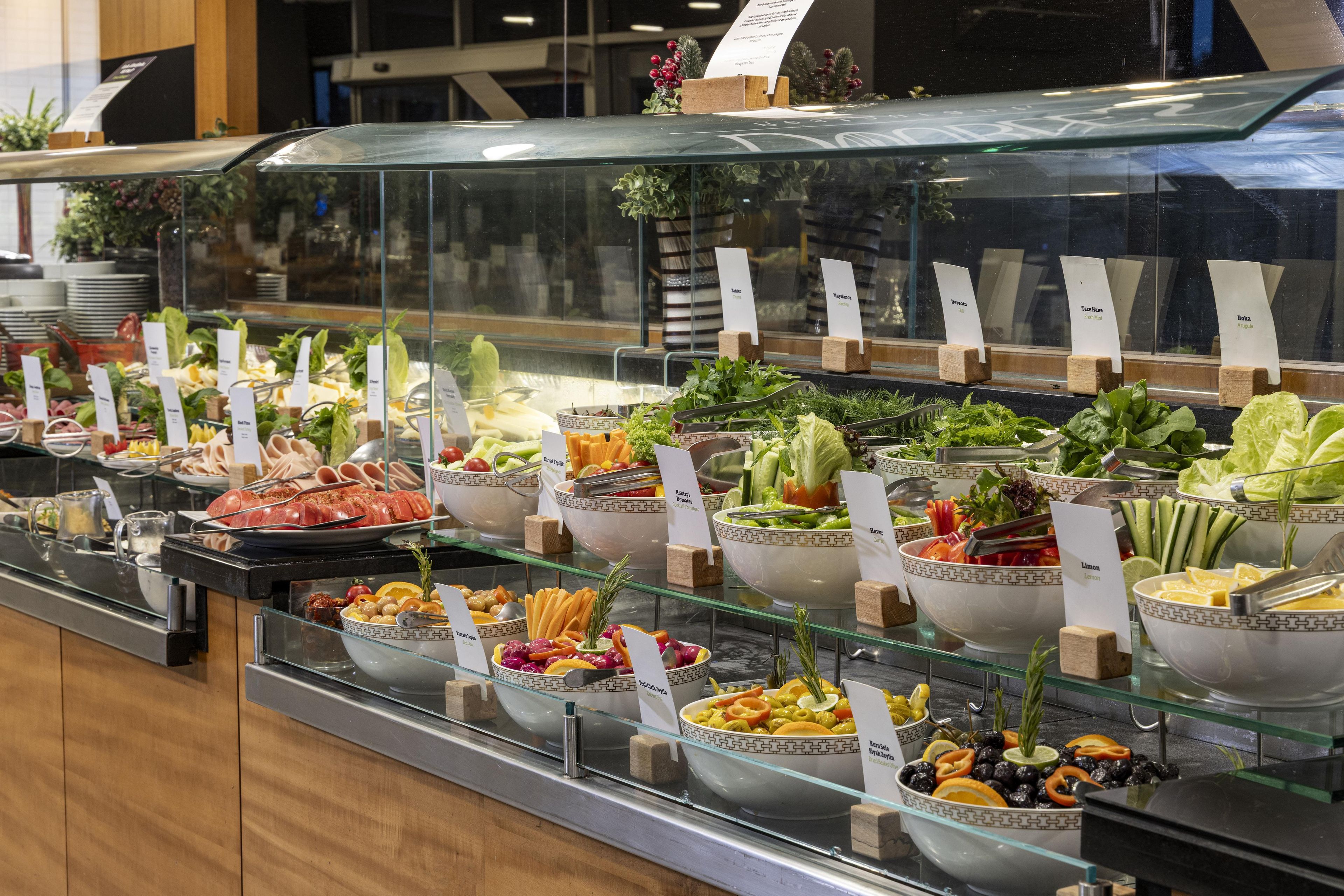 Buffet com diversas opções de comida e etiquetas.