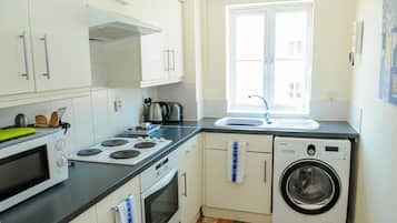 Um frigorífico, um micro-ondas, um forno, uma placa de cozinha