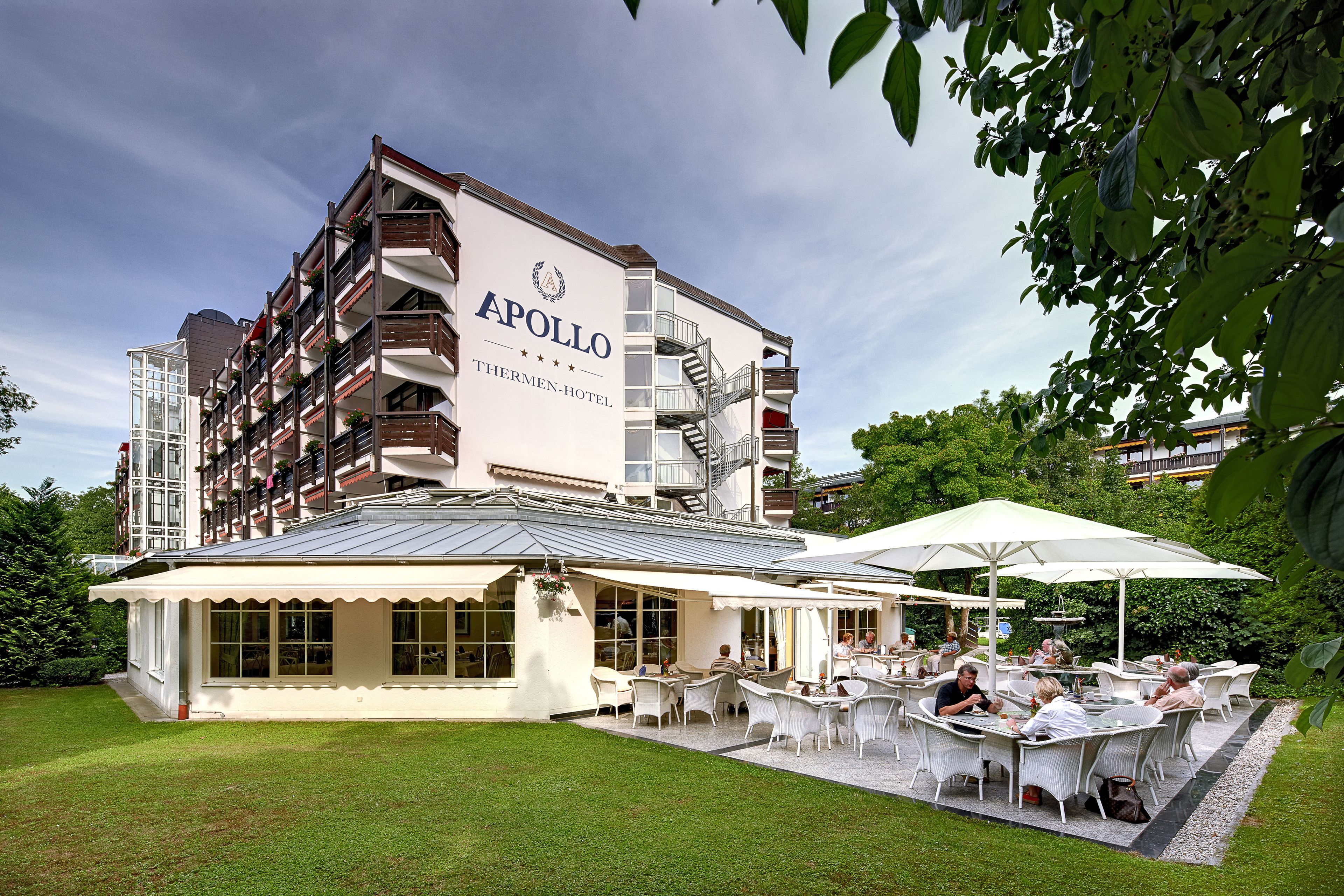 Hotel com área externa para sentar e uma grande placa.