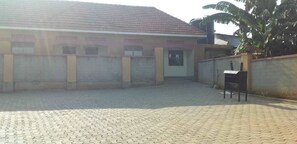 Um edifício com telhado telhado e pátio pavimentado.