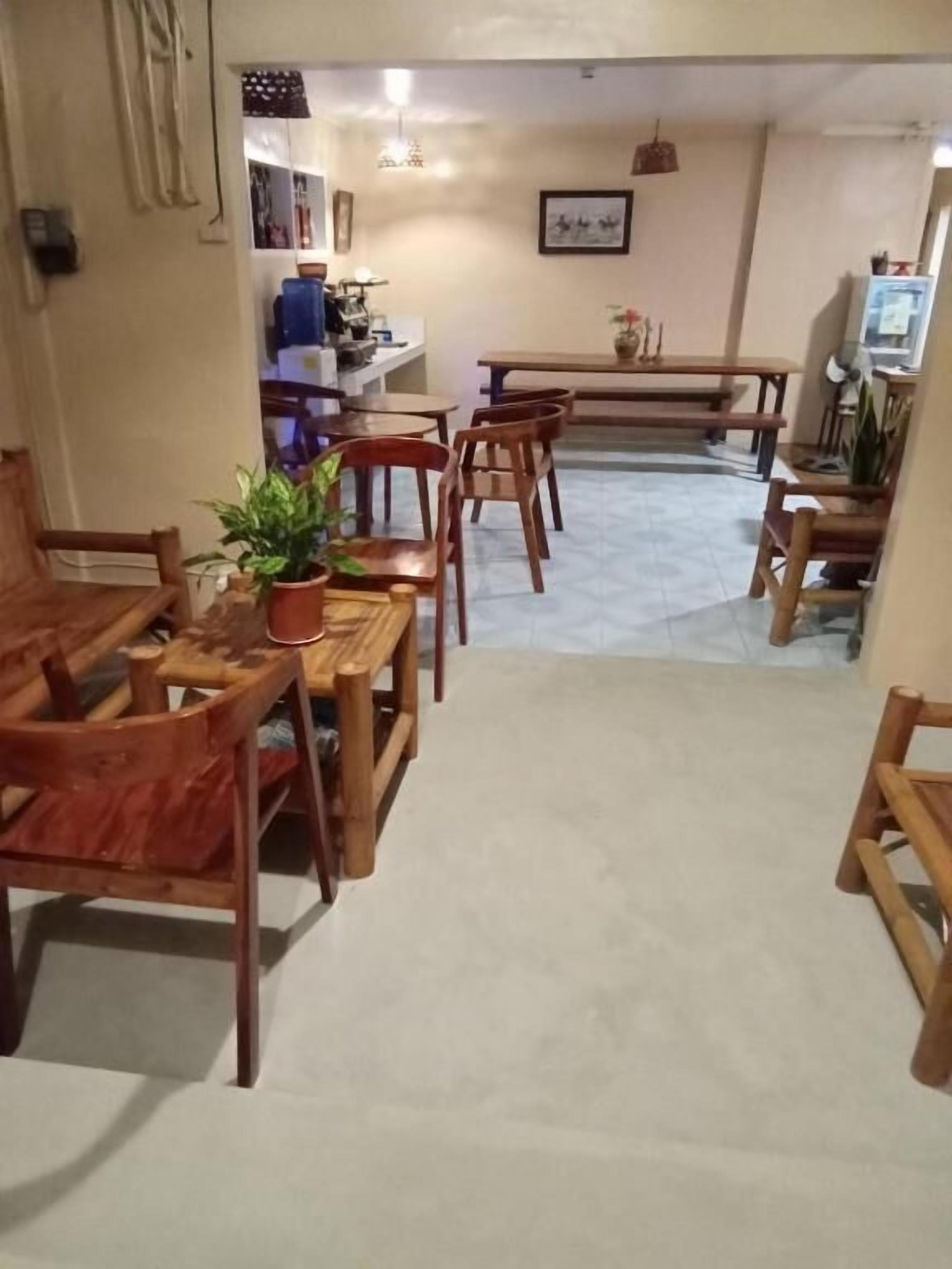 Uma sala de jantar com mobiliário de madeira e uma planta em vaso.