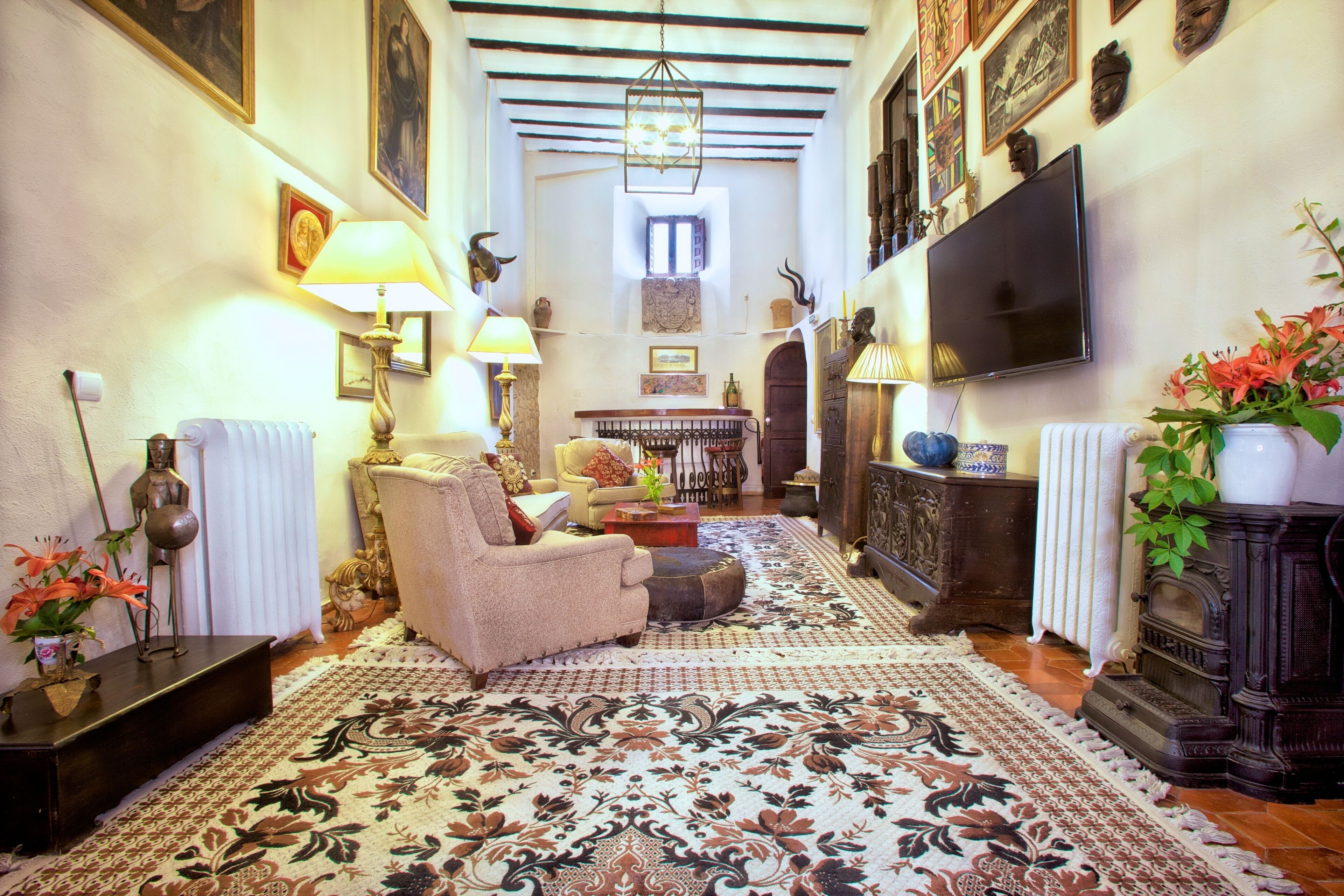 Uma sala de estar aconchegante com sofá, poltronas, mesinha de centro e lareira.