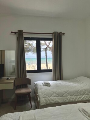 Quarto triplo, sacada, vista para o mar | Cofres nos quartos, escrivaninha, cortinas blackout, berços grátis