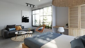 Quarto moderno com cama, sofá, poltrona, mesa pequena e planta em vaso.