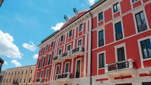 Um edifício vermelho e branco com várias varandas e janelas.