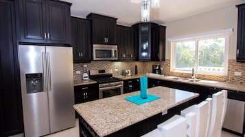 Um forno, uma placa de cozinha, uma måquina de café expresso