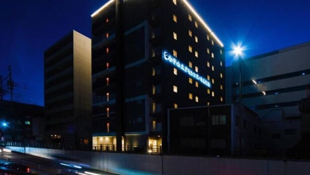 Um hotel com vários andares, sinalização iluminada e design arquitetônico moderno.